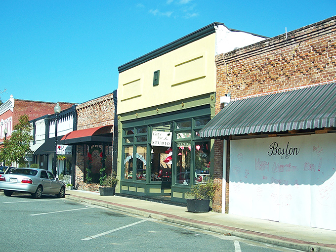 Main Street magic! These colorful storefronts aren't just buildings—they're time machines disguised as architecture, complete with charming awnings and small-town personality.