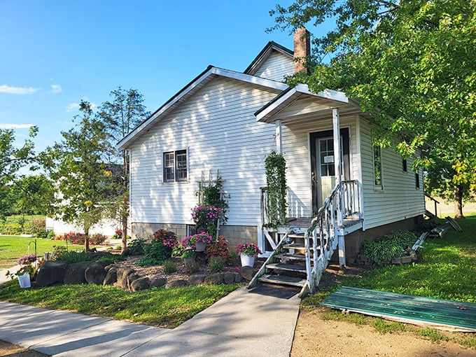 A slice of Americana awaits at Pleasant View Bakery's charming white farmhouse, where colorful flower beds welcome visitors to this Amish baking paradise.