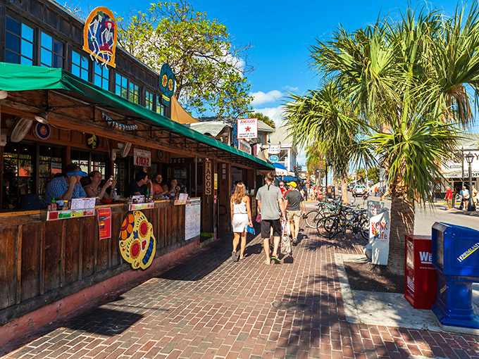 Colorful storefronts under swaying palms — the quintessential Keys experience where flip-flops are the dress code and relaxation is mandatory.