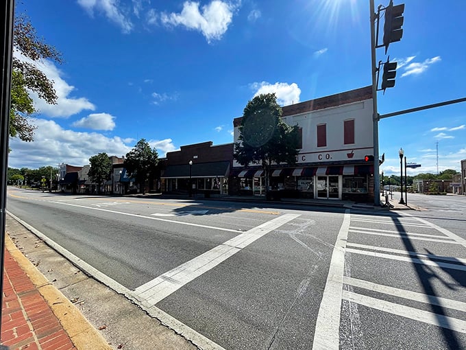 Historic charm meets small-town affordability along Sandersville's main street, where colorful storefronts welcome visitors with Southern hospitality and brick-paved sidewalks.