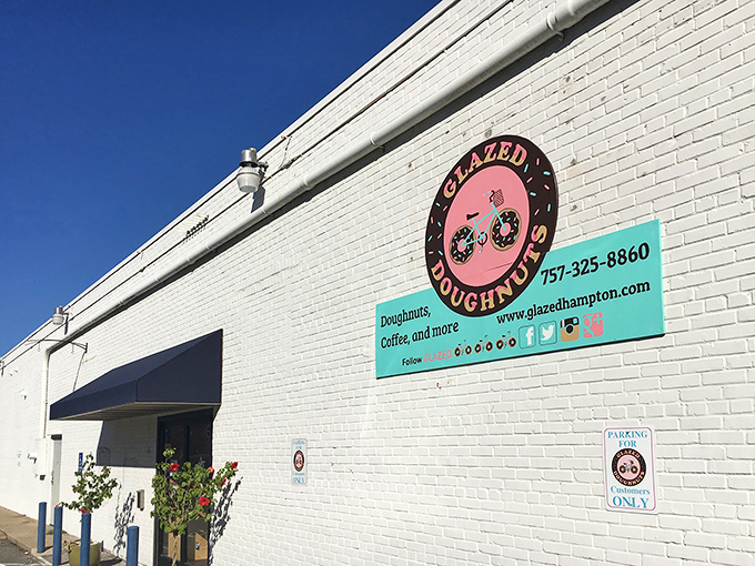 The unassuming exterior of Glazed Doughnuts in Hampton hides a world of pastry perfection. Sometimes the best treasures come in plain white packages.