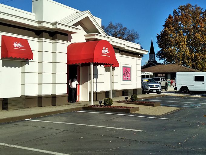 The iconic red awning of Holl's beckons chocolate lovers like a Swiss flag signaling delicious neutrality in the battle against willpower.