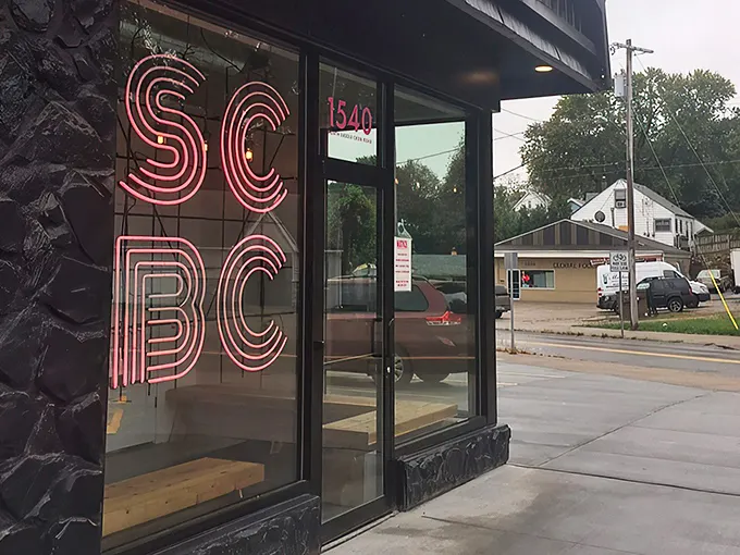That neon pink SCBC sign glows like a breakfast beacon, promising morning salvation to hungry Omahans seeking refuge from ordinary eggs.