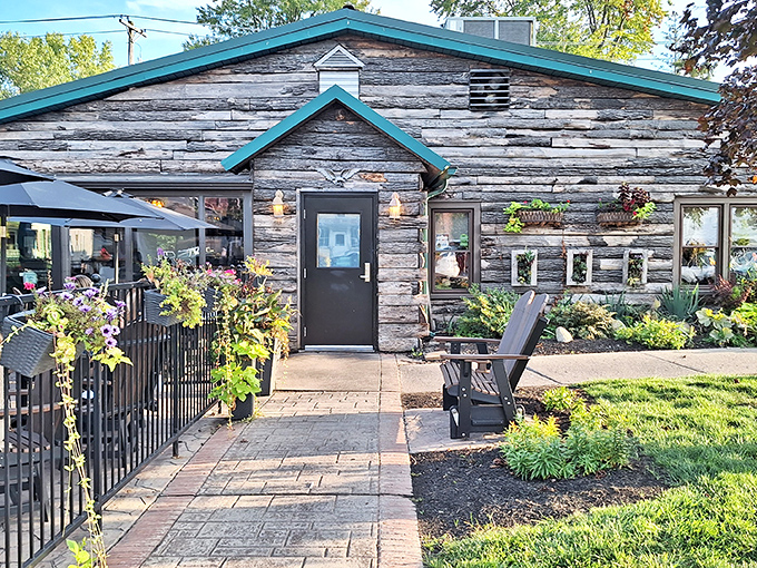 The weathered log cabin exterior with teal trim isn't trying to impress anyone, which is exactly why it does. Authentic Midwestern charm at its finest.