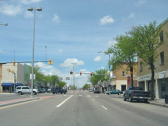 Main Street Lamar welcomes visitors with its classic small-town charm. Those red banners aren't just decorative—they're practically waving "affordable living this way!"