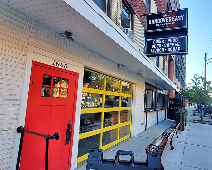 The iconic red door and yellow windows of HangOverEasy stand out like a beacon of breakfast hope on Neil Avenue. Morning salvation awaits inside.