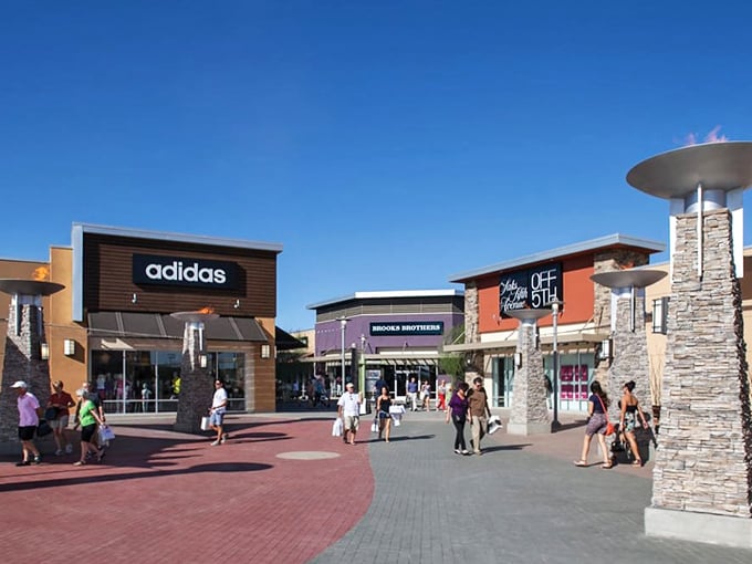 The architectural equivalent of a bargain hunter's dream—Phoenix Premium Outlets stands like a retail oasis against Arizona's blue sky, promising treasures within.