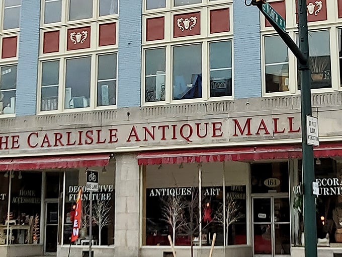 The iconic blue and red façade of The Carlisle Antique Mall beckons like a siren song for vintage enthusiasts on Carlisle's historic main street.
