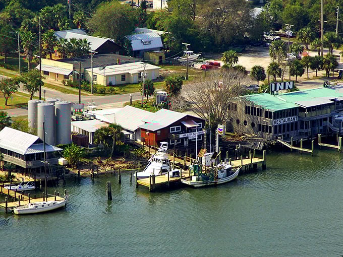 Weathered wooden structures perched over calm waters tell Apalachicola's story better than any brochure – a working waterfront where authenticity isn't manufactured.
