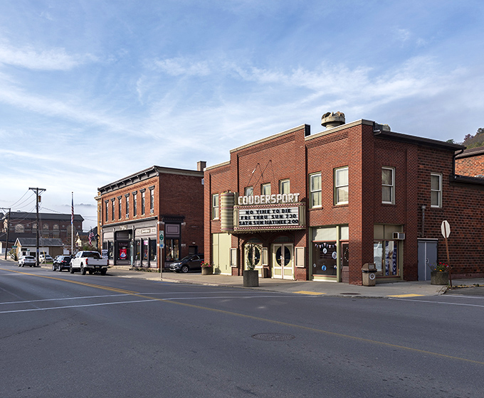 Main Street Coudersport in autumn glory – where brick buildings stand like sentinels against a backdrop of hills ablaze with fall foliage. Small-town America at its most photogenic. 