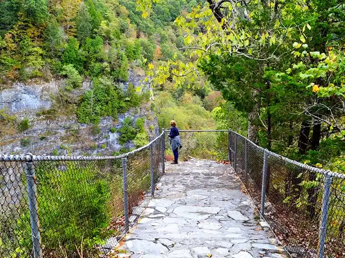 Mother Nature's architectural masterpiece frames the railroad tracks like she's showing off a million years of erosion artistry.