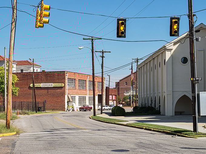 Broad Street stretches into the distance like a Norman Rockwell painting come to life, where autumn trees frame historic storefronts under Alabama's impossibly blue sky.