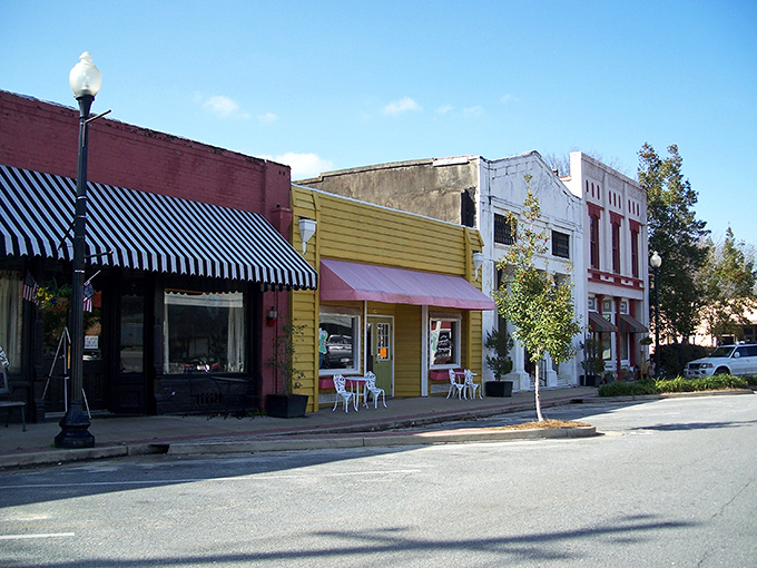 Main Street magic! These colorful storefronts aren't just buildings—they're time machines disguised as architecture, complete with charming awnings and small-town personality.
