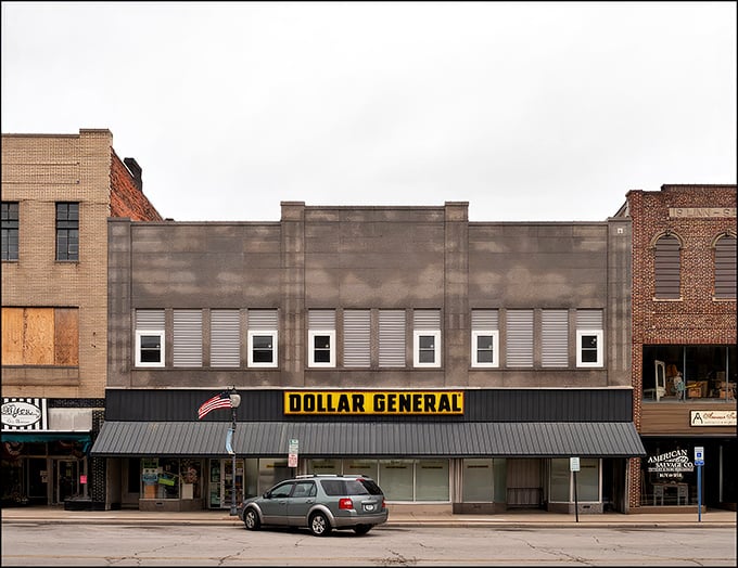 Main Street Americana at its finest – brick storefronts standing shoulder to shoulder like old friends who've weathered decades of small-town stories together.