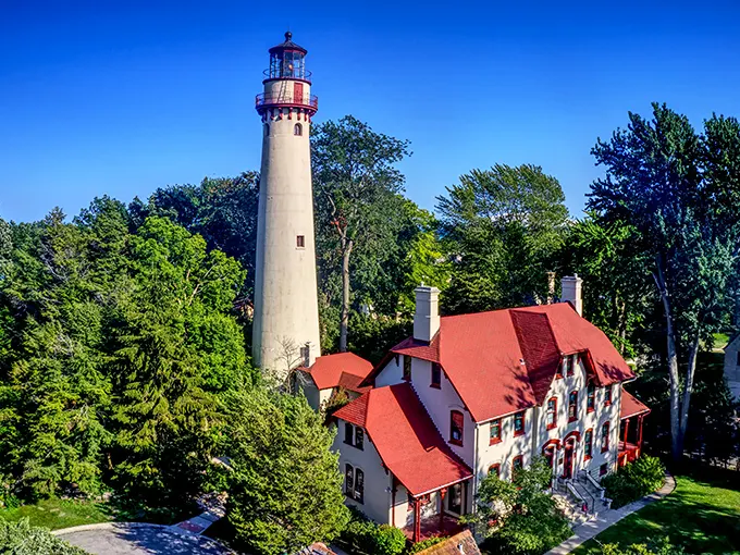 The towering Grosse Point Lighthouse stands sentinel among lush greenery, a maritime surprise in the Prairie State that's been guiding sailors since the 1870s.