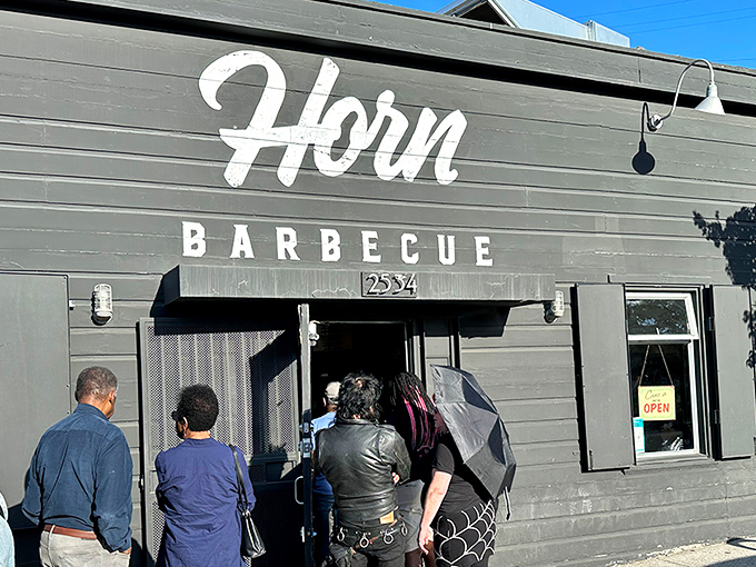The unassuming gray exterior of Horn Barbecue belies the smoky treasures within—like finding the barbecue equivalent of Fort Knox hiding in plain sight.