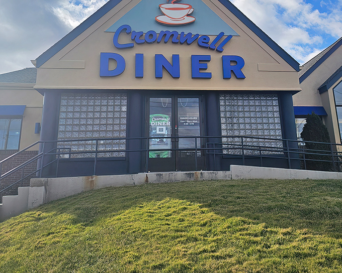 The iconic blue sign of Cromwell Diner stands like a beacon for hungry travelers, promising comfort food salvation just off Route 372.
