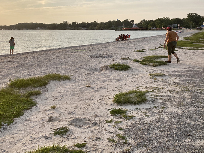 The perfect marriage of land and lake – smooth stones stretching toward Lake Erie's horizon while visitors stroll along nature's masterpiece of polished pebbles.