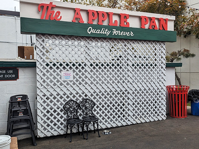The unassuming white exterior of The Apple Pan stands like a time capsule on West Pico Boulevard, its vintage sign promising "Quality Forever" – a bold claim it's managed to fulfill for decades.