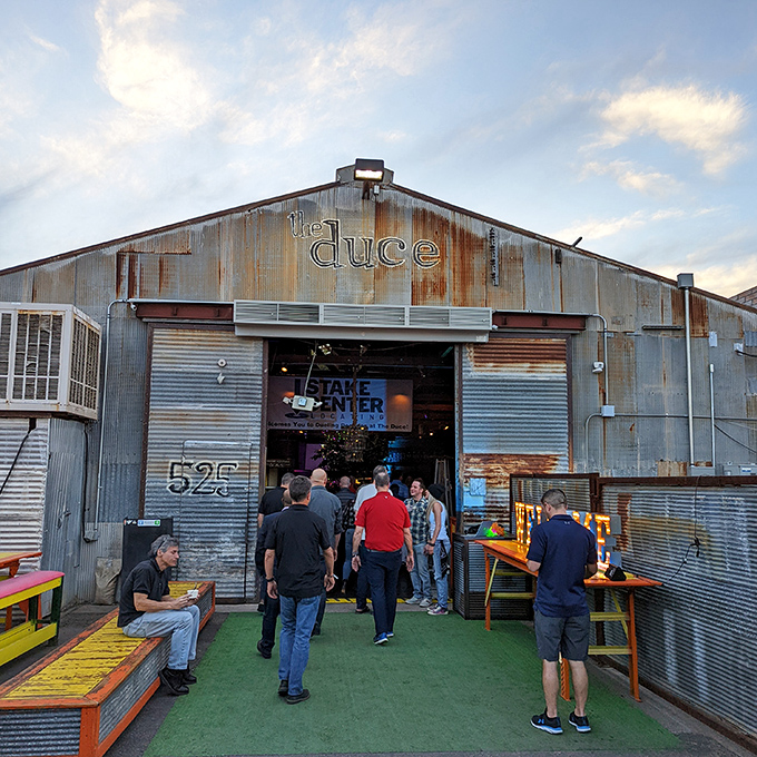 The Duce's exterior is industrial chic personified—corrugated metal, vintage signage, and that gleaming Airstream trailer promising culinary adventures within.