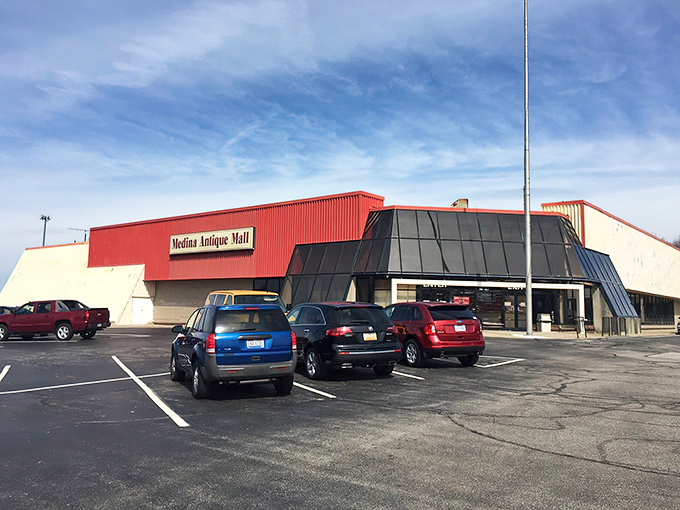 The unassuming red-trimmed exterior of Medina Antique Mall—like finding a treasure chest disguised as a regular building.