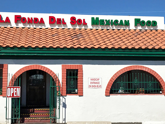 The iconic terra cotta roof and vibrant red-and-green signage of La Fonda Del Sol promises authentic Mexican flavors before you even step inside.