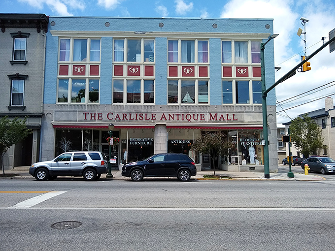 The striking blue façade of The Carlisle Antique Mall stands as a beacon for treasure hunters on Hanover Street, promising adventures in every window.