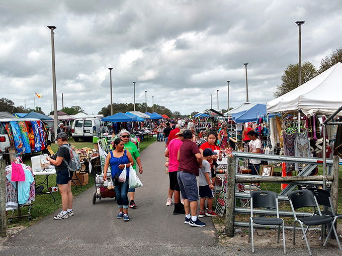 Treasure hunters navigate the bustling aisles of Plant City's weekend wonderland. The thrill of discovery hangs in the air like Florida humidity—inescapable and oddly energizing.