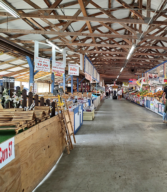 The indoor market stretches like a treasure-filled horizon, with wooden beams overhead and endless stalls beckoning shoppers to explore their wares.