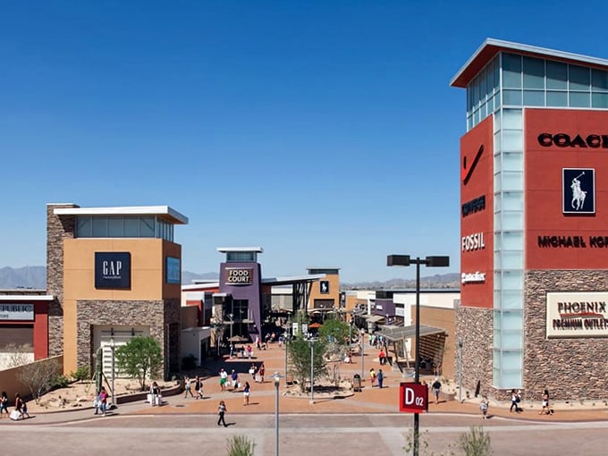 The architectural equivalent of a bargain hunter's dream—Phoenix Premium Outlets stands like a retail oasis against Arizona's blue sky, promising treasures within.