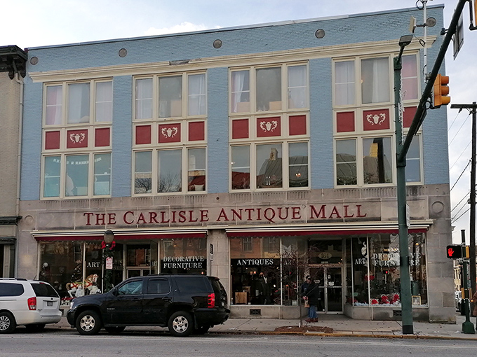 The iconic blue and red façade of The Carlisle Antique Mall beckons like a siren song for vintage enthusiasts on Carlisle's historic main street.