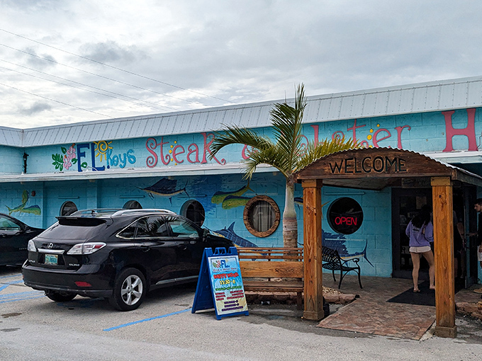 The vibrant turquoise exterior isn't just eye-catching—it's practically shouting "seafood paradise ahead!" through its nautical porthole windows.