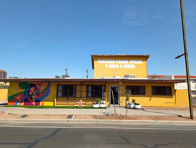 That cheerful yellow exterior and vibrant mural practically shout "comfort food paradise" from across the street.