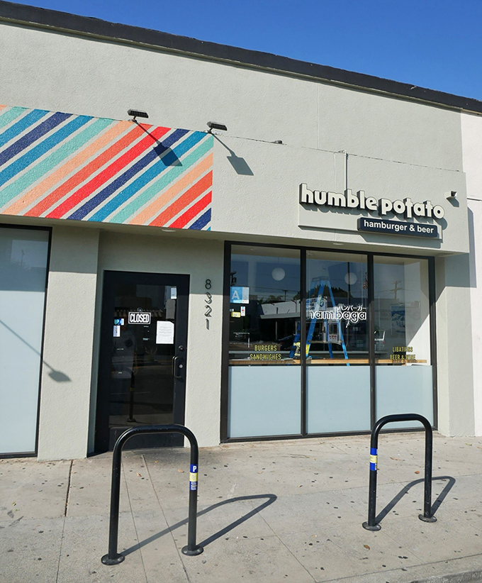 The colorful diagonal stripes adorning Humble Potato's exterior aren't just for show—they're a preview of the vibrant flavor combinations waiting inside this unassuming gem.