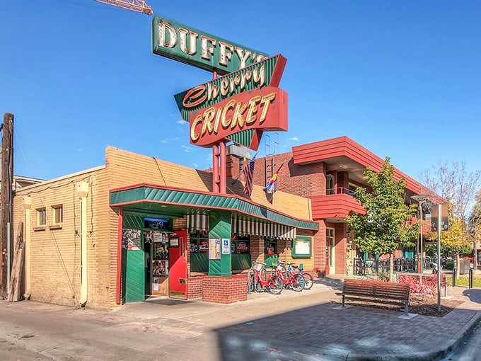 The iconic Duffy's Cherry Cricket sign stands as a beacon of burger bliss in Denver's Cherry Creek neighborhood, promising unpretentious delights within those brick walls.
