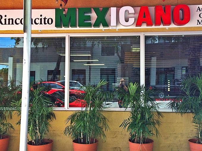 The sunshine-yellow exterior with its festive red awning isn't just a restaurant—it's a landmark for burrito pilgrims throughout Florida.