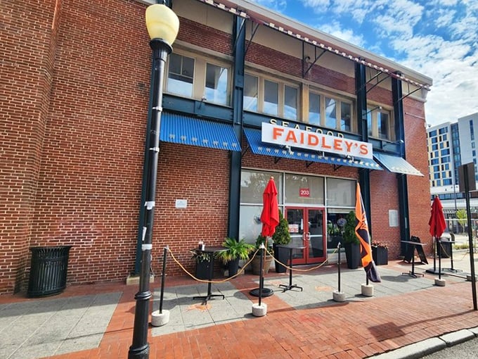 The brick facade and iconic blue awning of Faidley's stands like a seafood beacon in Baltimore, promising treasures of the Chesapeake within.