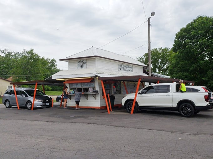 The humble white building with its distinctive orange-red supports stands like a time capsule of American drive-in culture. Simple perfection awaits.