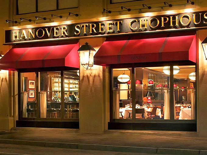 The iconic red awning beckons like a culinary lighthouse, promising refuge from ordinary dining experiences in downtown Manchester.