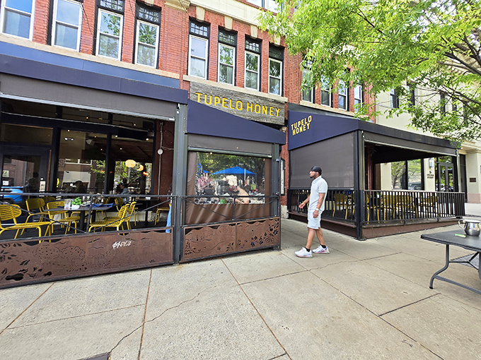 The golden-lettered storefront beckons like a Southern siren song, promising comfort food salvation on a busy Asheville street.