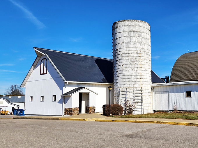 The iconic white barn exterior stands proudly against blue Ohio skies, complete with its towering silo—a beacon for hungry travelers seeking comfort food paradise.