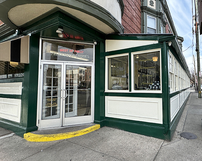 The iconic green-trimmed corner building of Famous 4th Street Delicatessen stands as a beacon of culinary tradition in Philadelphia's Queen Village neighborhood.