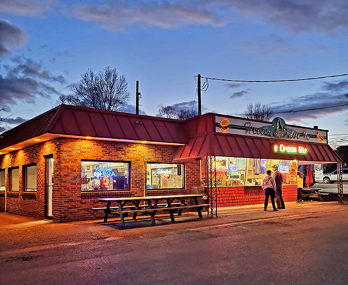 Twilight transforms this humble brick building into a beacon of comfort food promise. The red roof glows like a dinner bell calling hungry travelers home.
