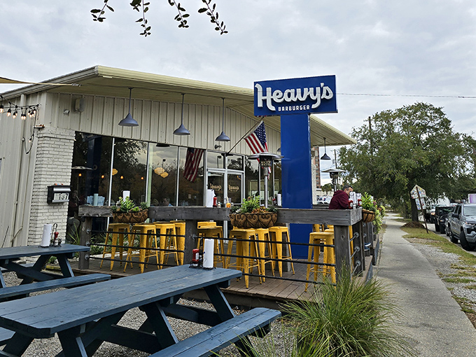 The blue sign beckons like a lighthouse for the hungry—Heavy's Barburger's unassuming exterior hides culinary treasures within.