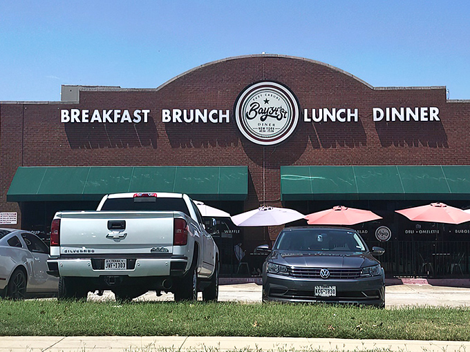 The brick facade with teal awnings isn't just inviting—it's practically shouting "Come get breakfast!" Those white picnic tables are waiting for your morning revelation.
