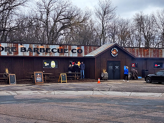 The weathered corrugated metal exterior of Big Bore Barbecue stands as a rustic beacon for meat lovers—industrial chic meets smokehouse authenticity.