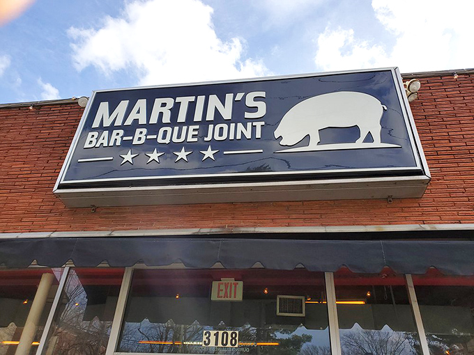 The red brick exterior of Martin's Bar-B-Que Joint beckons hungry pilgrims with its no-nonsense façade and the promise of smoky delights within.