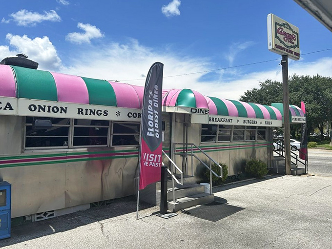 That iconic pink and green striped awning isn't just eye-catching—it's a time machine disguised as a diner, beckoning hungry travelers since long before Instagram made everything "retro."