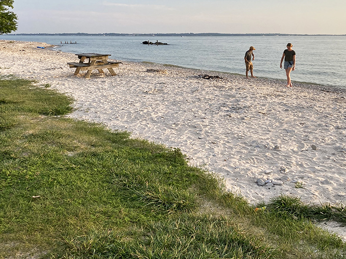 The perfect marriage of land and lake – smooth stones stretching toward Lake Erie's horizon while visitors stroll along nature's masterpiece of polished pebbles.