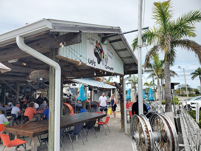 The Ugly Grouper's weathered wooden exterior and pastel-colored sign perfectly capture Florida's laid-back beach culture where flip-flops qualify as formal footwear.